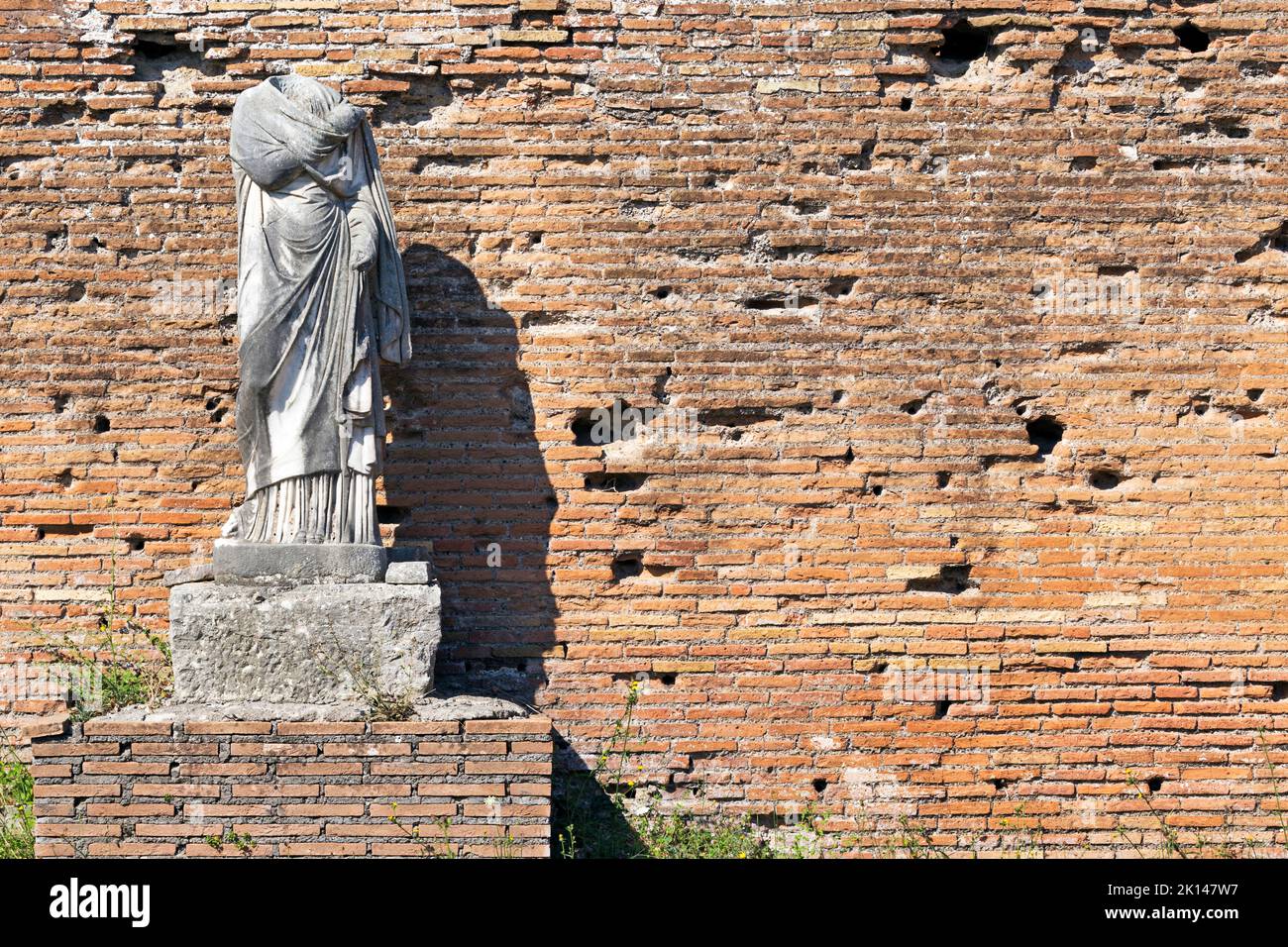 Ancient Roman art with ruin of marble statue dressed with toga with ...