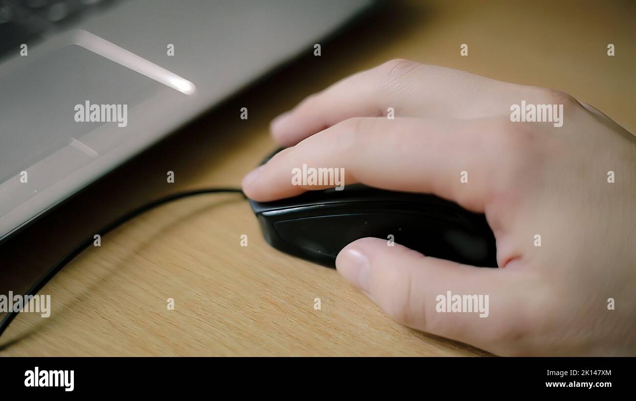 Hand of young caucasian man clicking and scrolling mouse Stock Photo ...