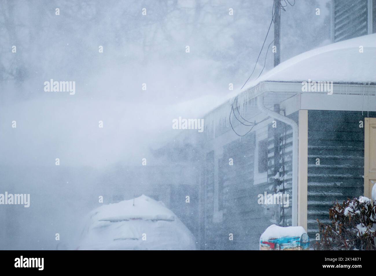 Snow blowing off the roof of a residential house during a blizzard on ...