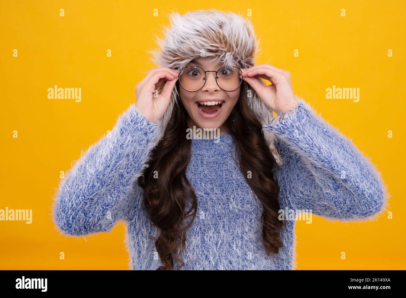 Fashion happy young woman in knitted hat and sweater having fun over ...