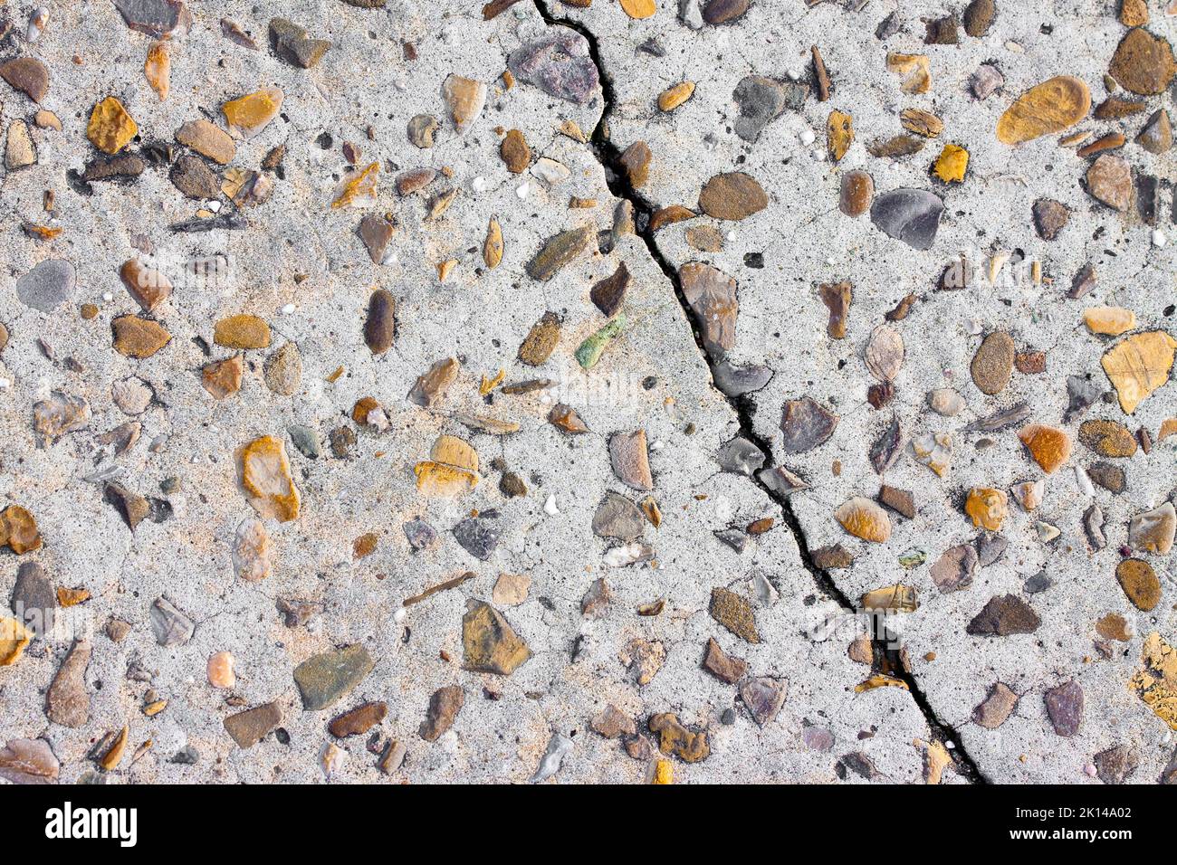 Concrete and gravel floor with dangerous cracks Stock Photo - Alamy