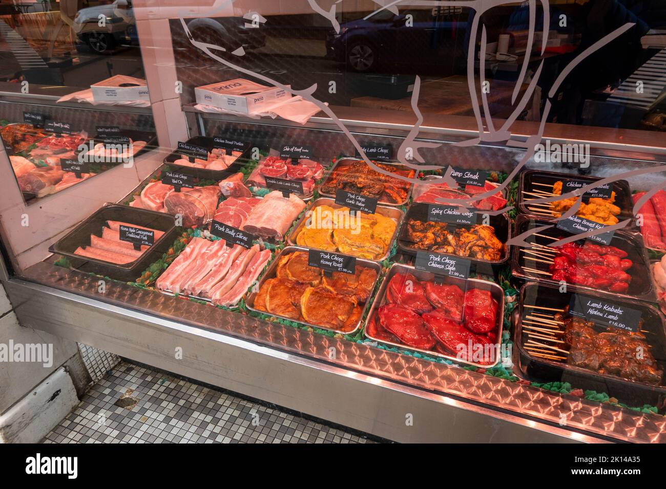 A view of a butchers shop front with all types of meat freshly prepared ...