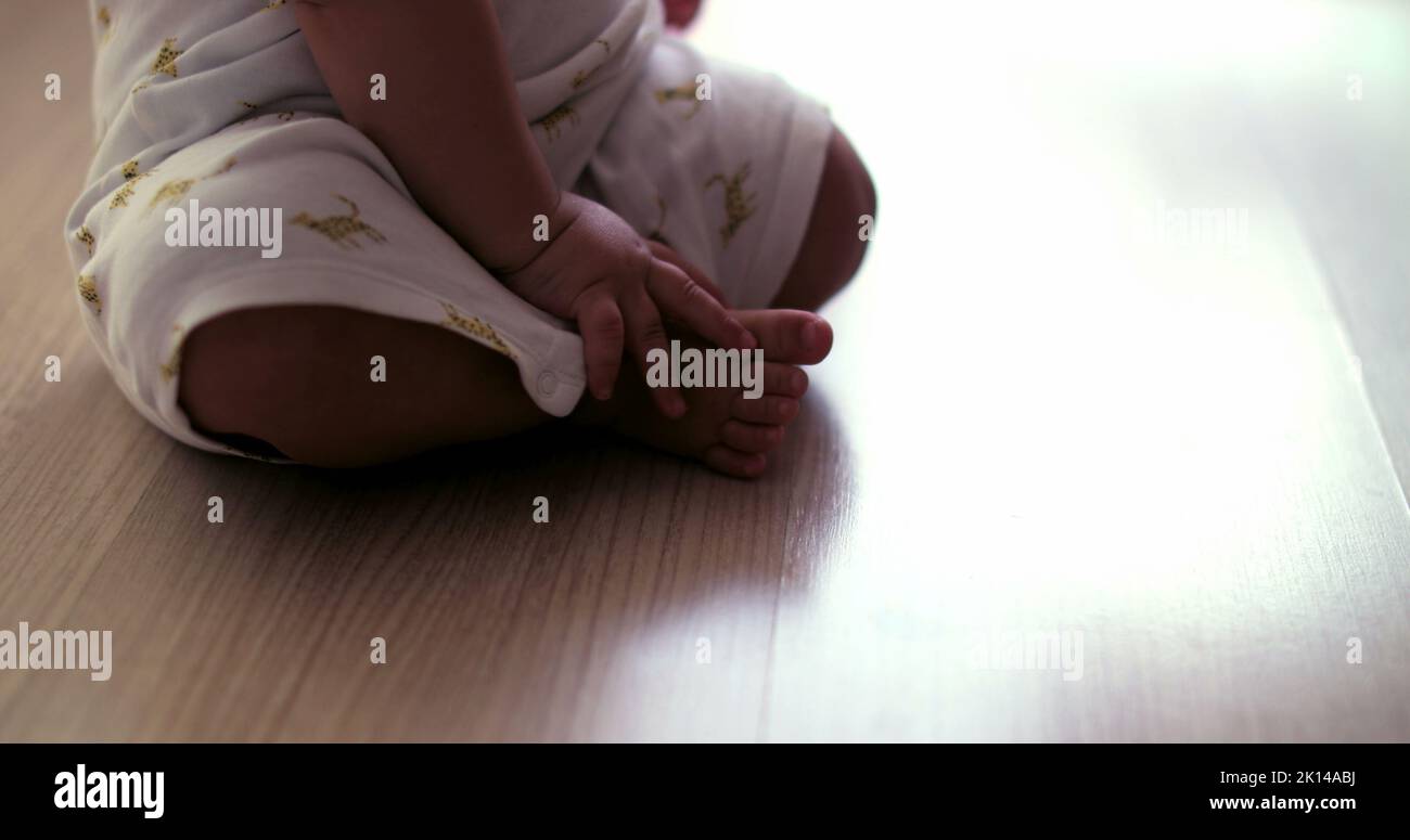 Cute baby looking inside drawer furniture, infant standing, child ...