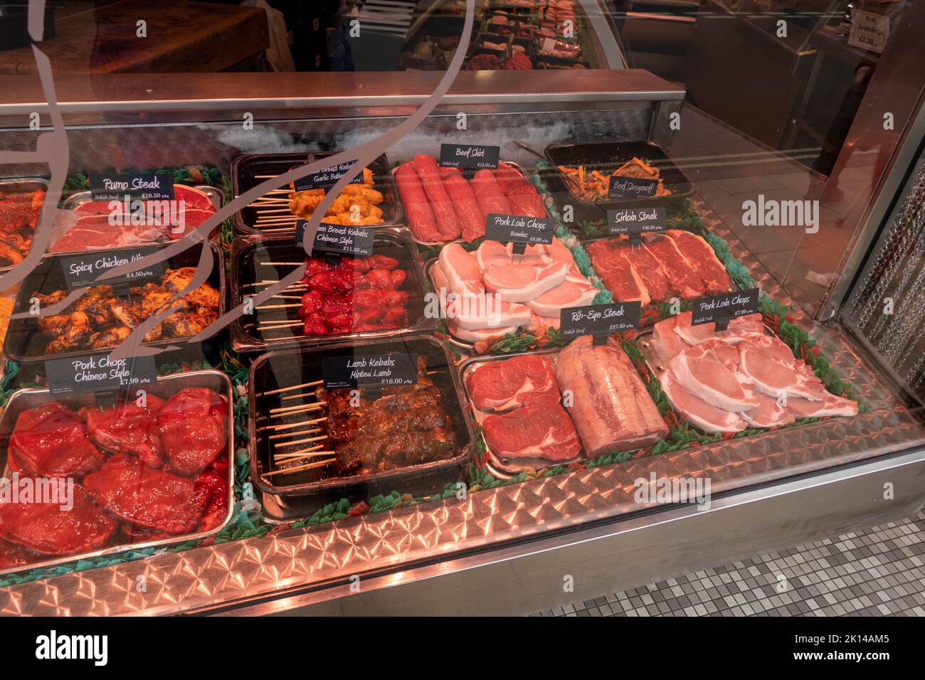 A view of a butchers shop front with all types of meat freshly prepared ...