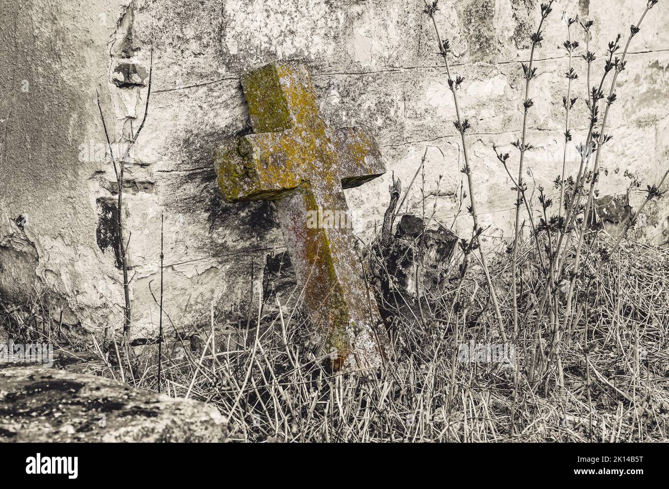 Old stone cross is propped against the wall of a ruined temple Stock ...