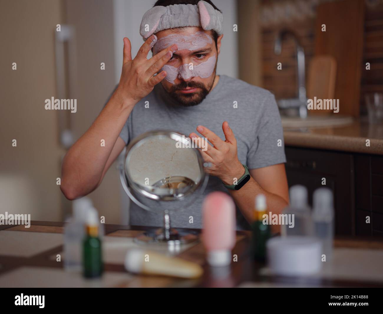 Men's beauty concept. caucAsian guy checking his skin. man looking into ...