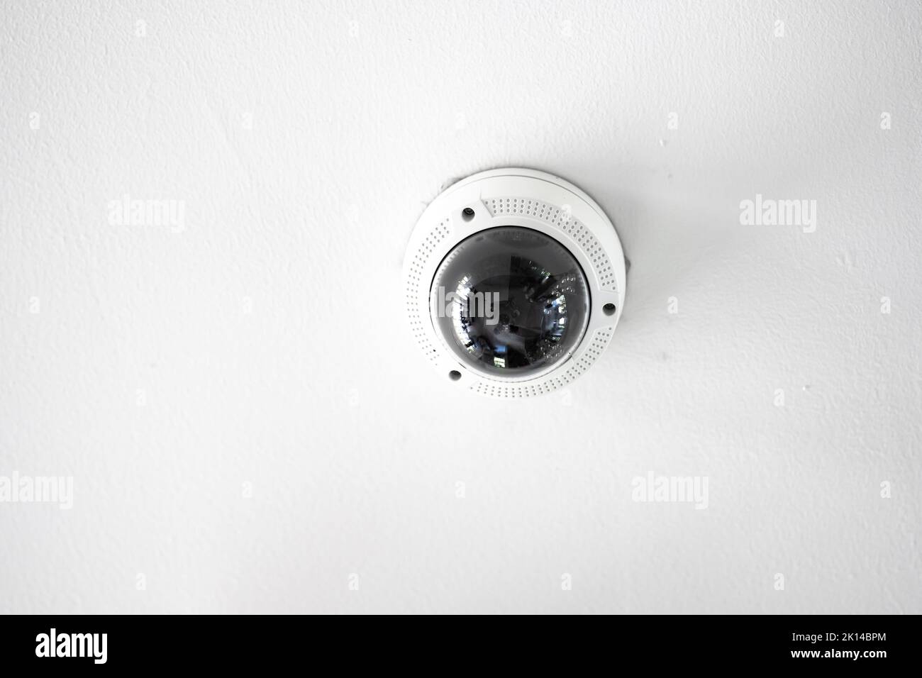 White CCTV with acrylic glass dome cover camera len in the centre ...