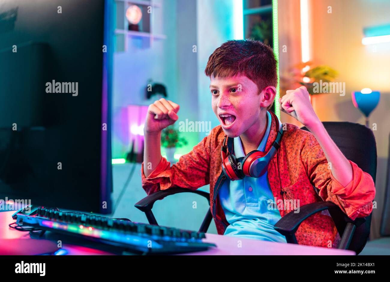 shouting teenager kid celebrating win by shouting while playing online ...
