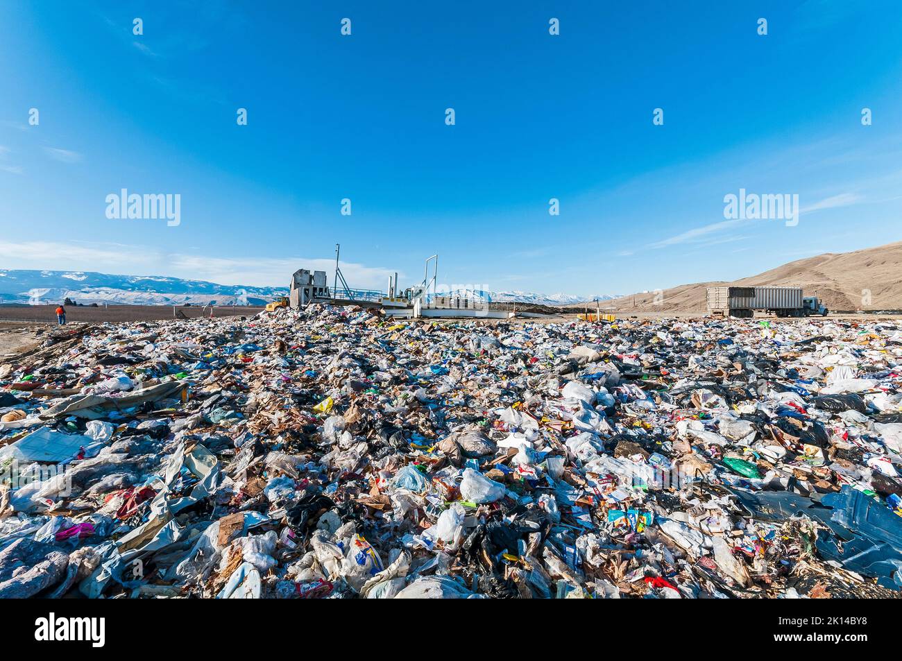 A sea of solid waste at an active landfill, with a trailer tipper and a ...
