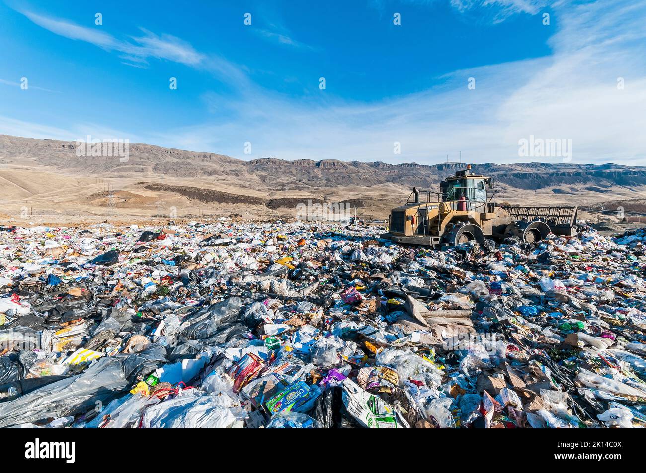 A soil compactor crushing solid waste at an active landfill Stock Photo ...