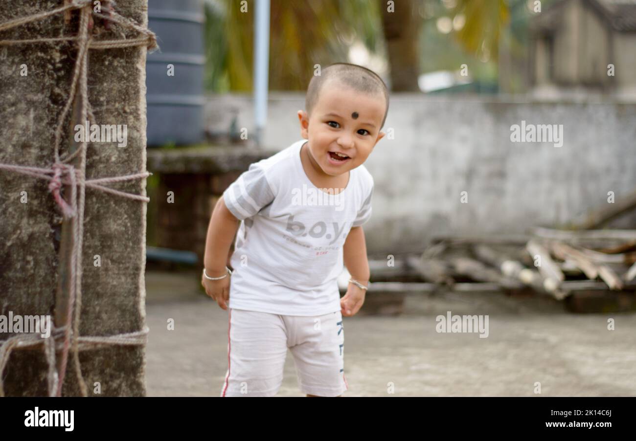 Cute smart naughty baby making a funny and looking at camera. Happy ...