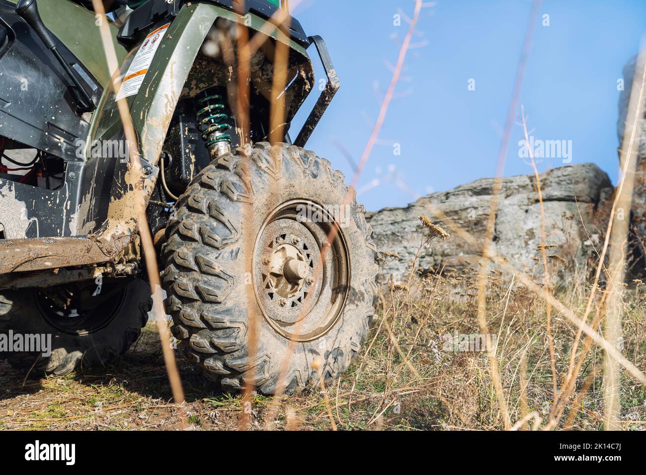 Close-up detail bottom POV view 4x4 awd ATV vehicle on dirt gravel ...
