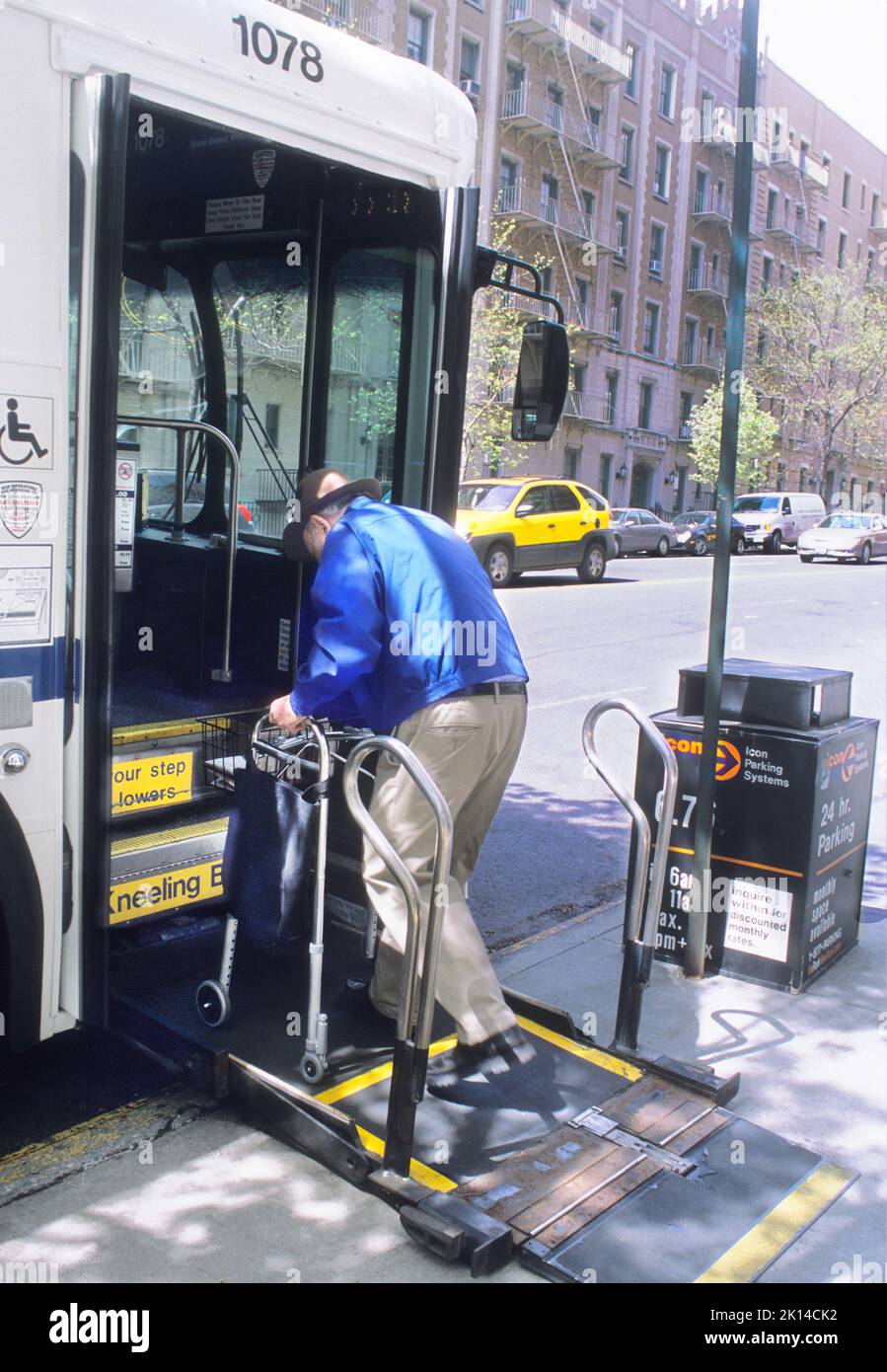 Disabled man using a ramp to enter New York City MTA bus. Metropolitan ...