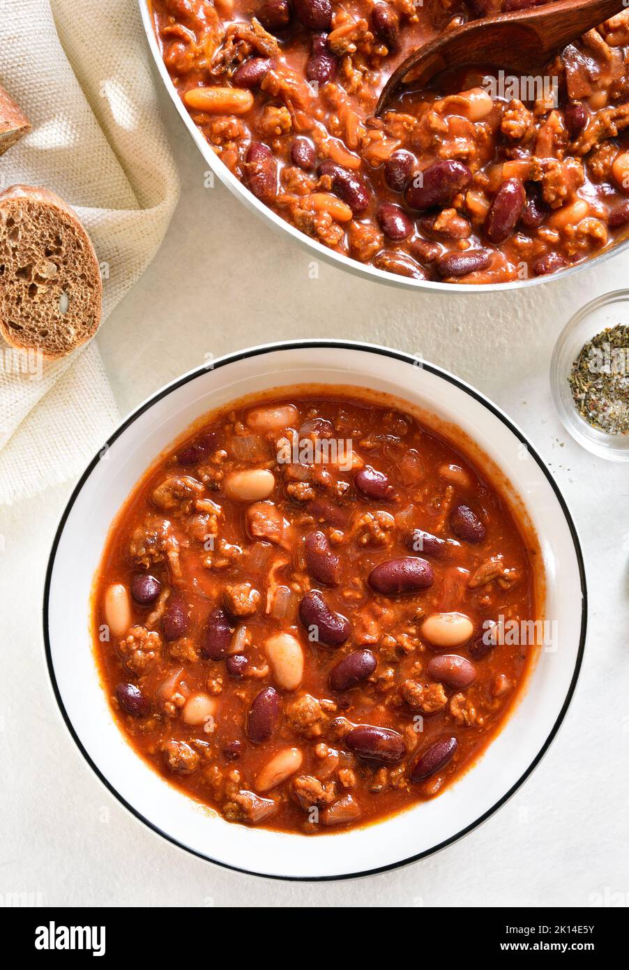 Cowboy beans with ground beef, jalapeno pepper and bacon in bowl over ...