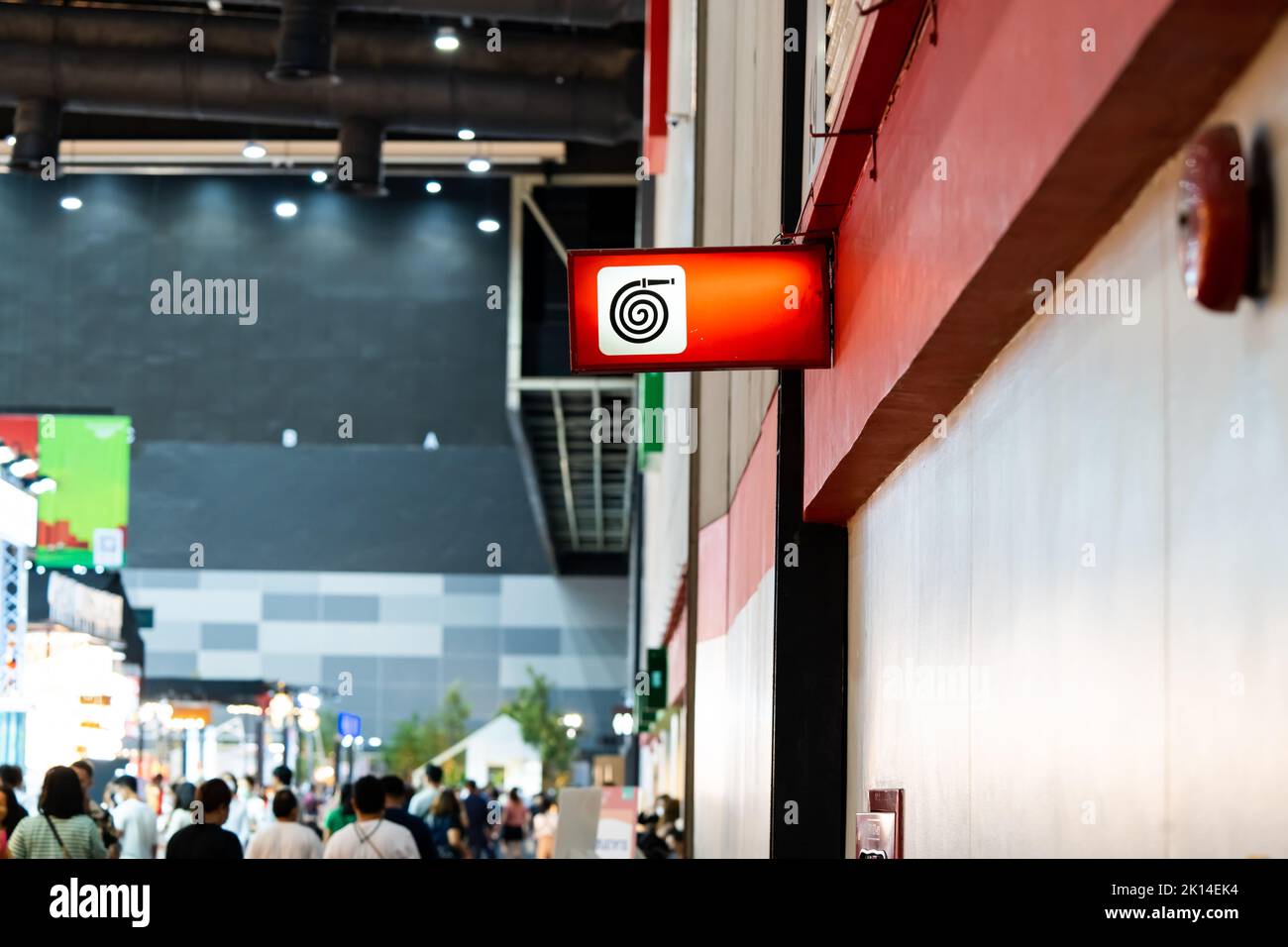 A fire equipment sign installed on a wall. Red light on to be ...