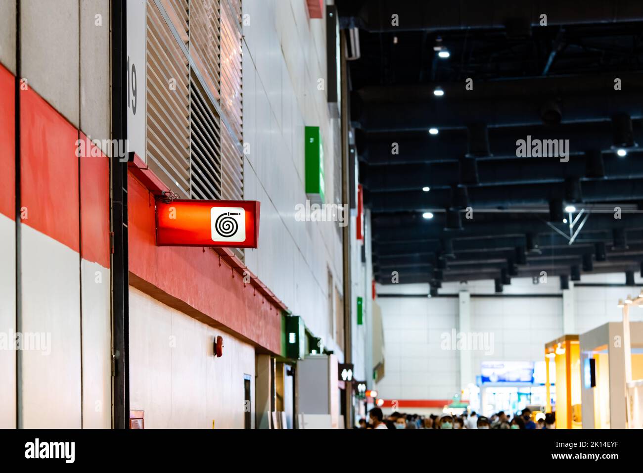 A fire equipment sign installed on a wall. Red light on to be ...