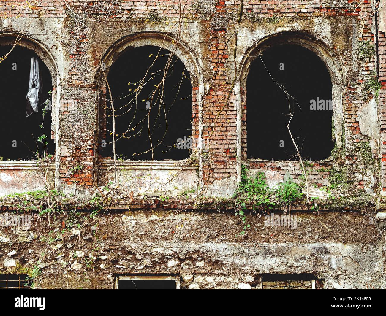 Abandoned building with arched windows. Arched window openings without ...