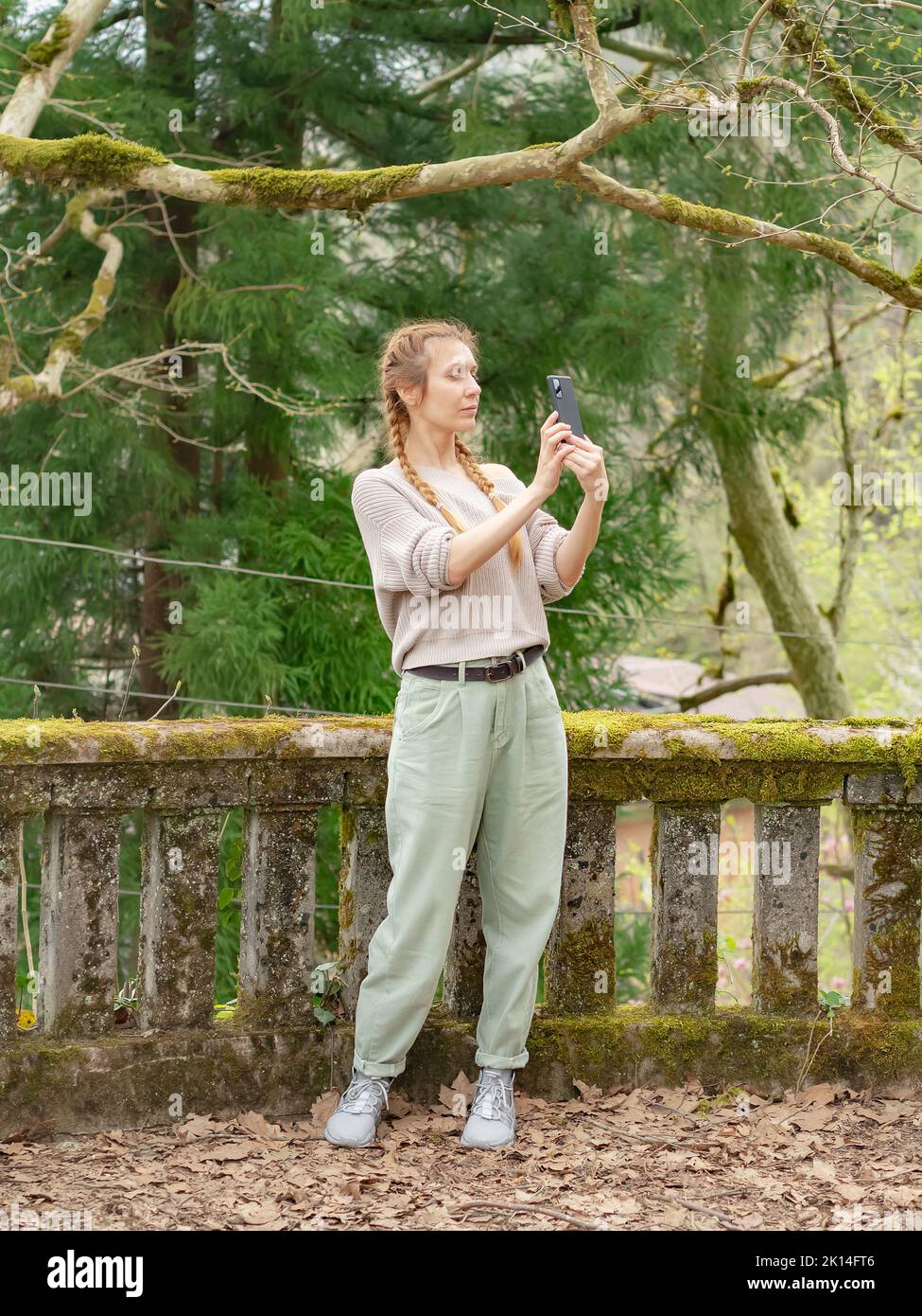 Woman photographing abandoned landmarks. Woman taking pictures of the ...
