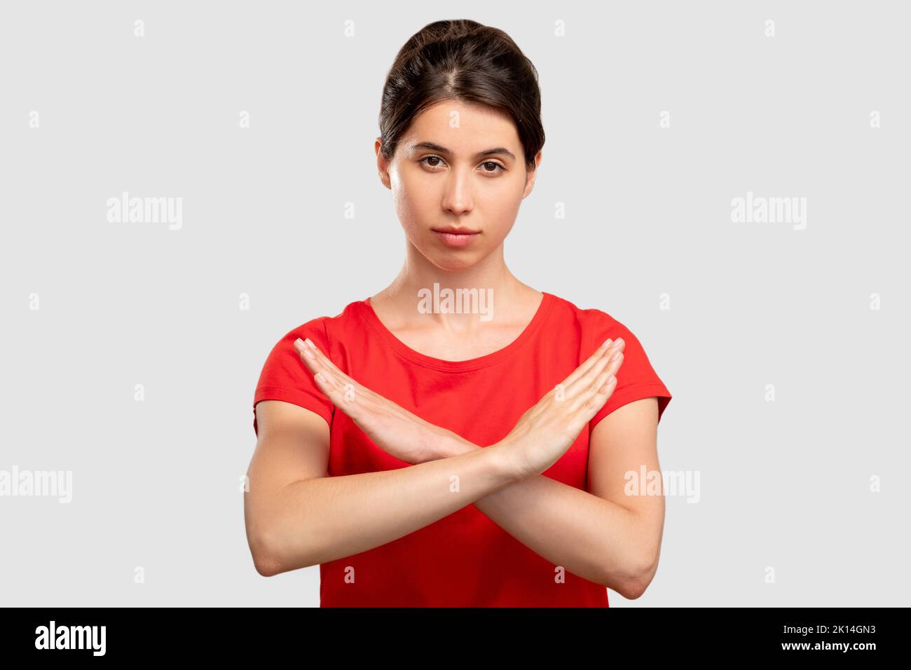 Stop sign. Forbidden gesture. Woman in red t-shirt crossing hands ...