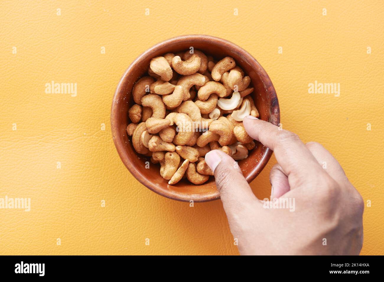 hand pick cashew nut from a bowl Stock Photo - Alamy