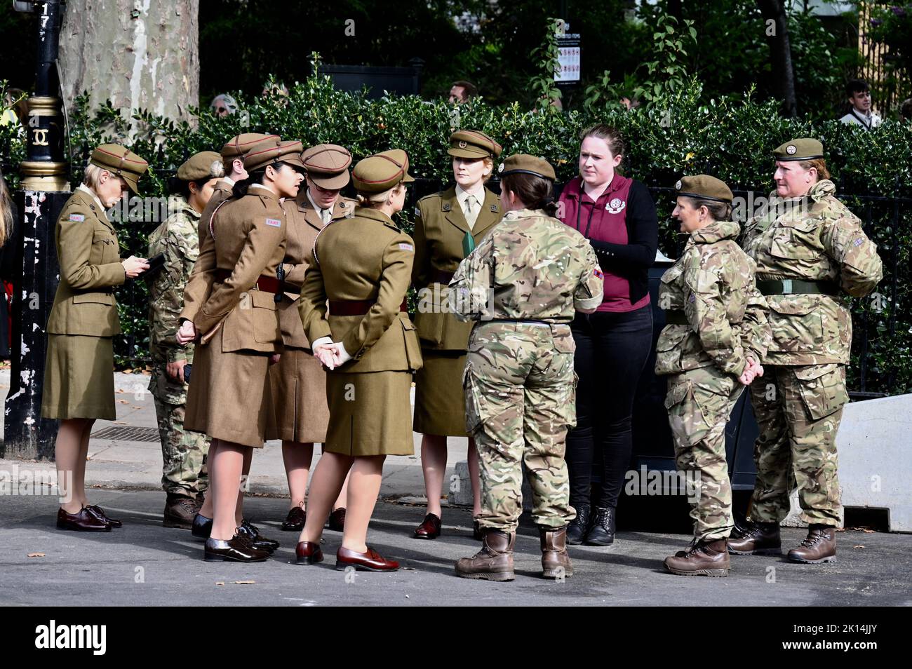 London, UK. Soldiers in modern kit met women dressed in vintage First ...