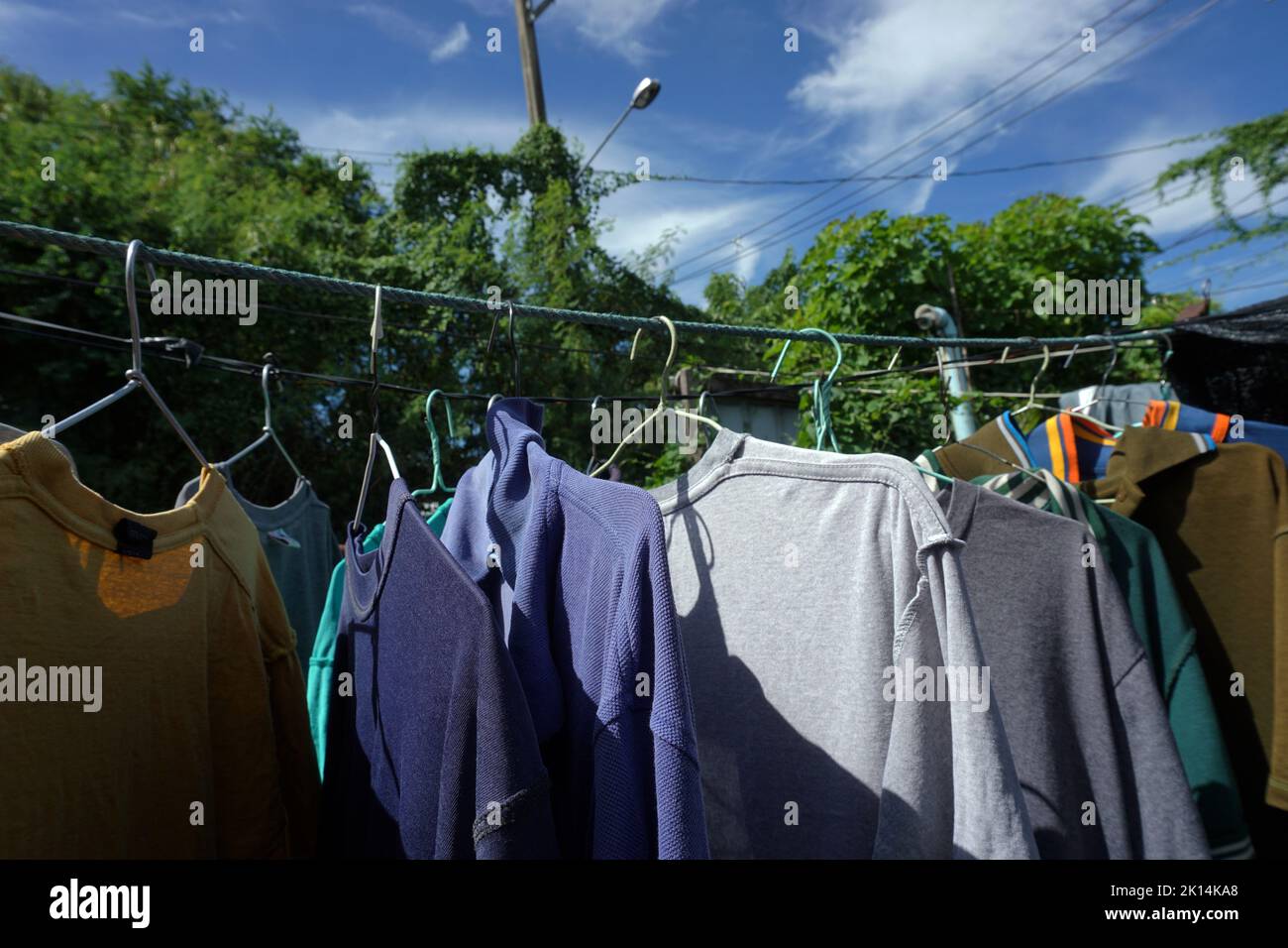 Hang clothes and pants to dry after washing Stock Photo - Alamy