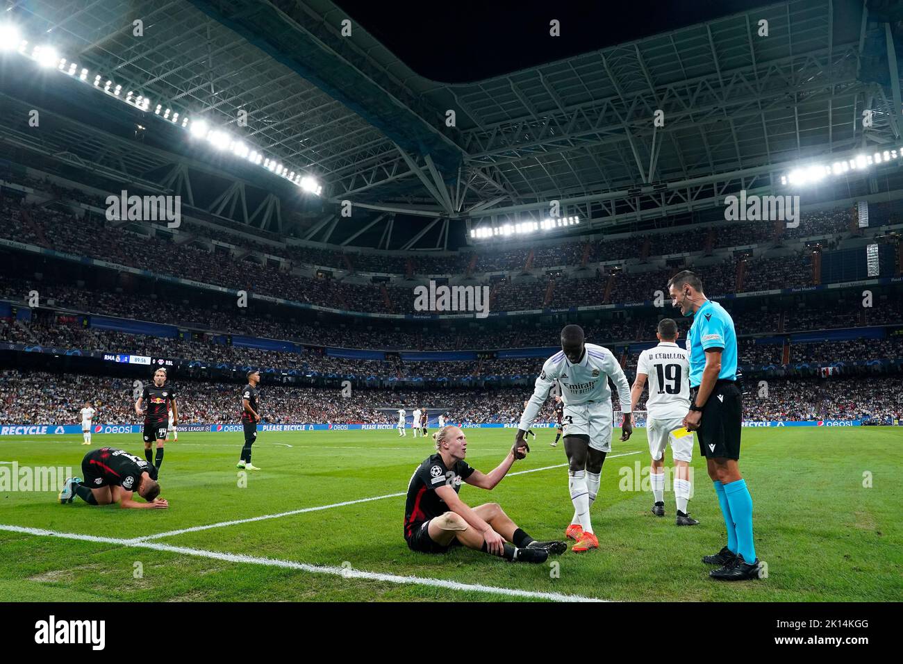 Ferland Mendy of Real Madrid helps Xaver Schlager of RB Leipzig during ...