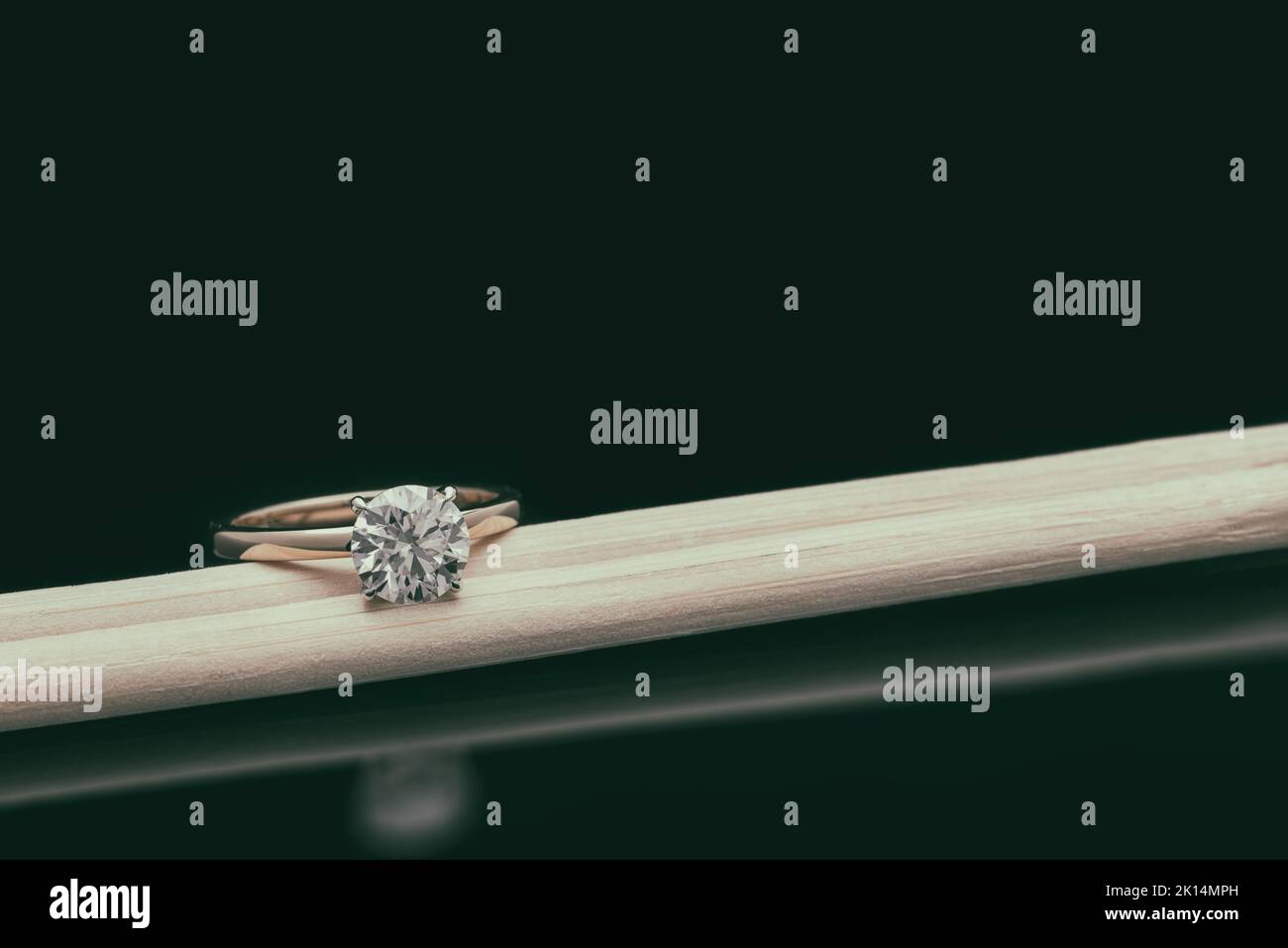 Solitaire Engagement Ring With Diamond on Wooden Chopsticks Stock Photo ...