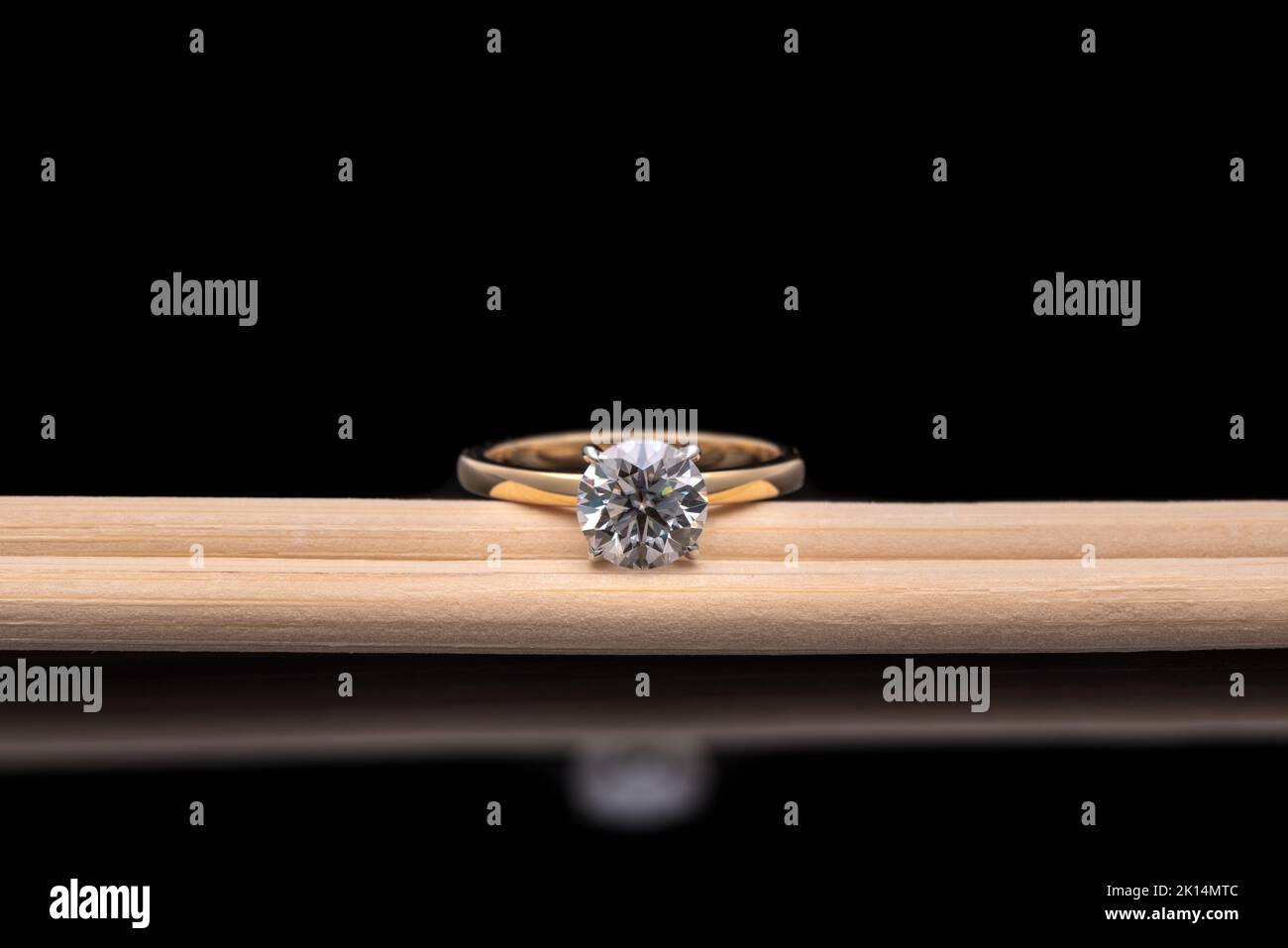 Solitaire Engagement Ring With Diamond on Wooden Chopsticks Stock Photo ...