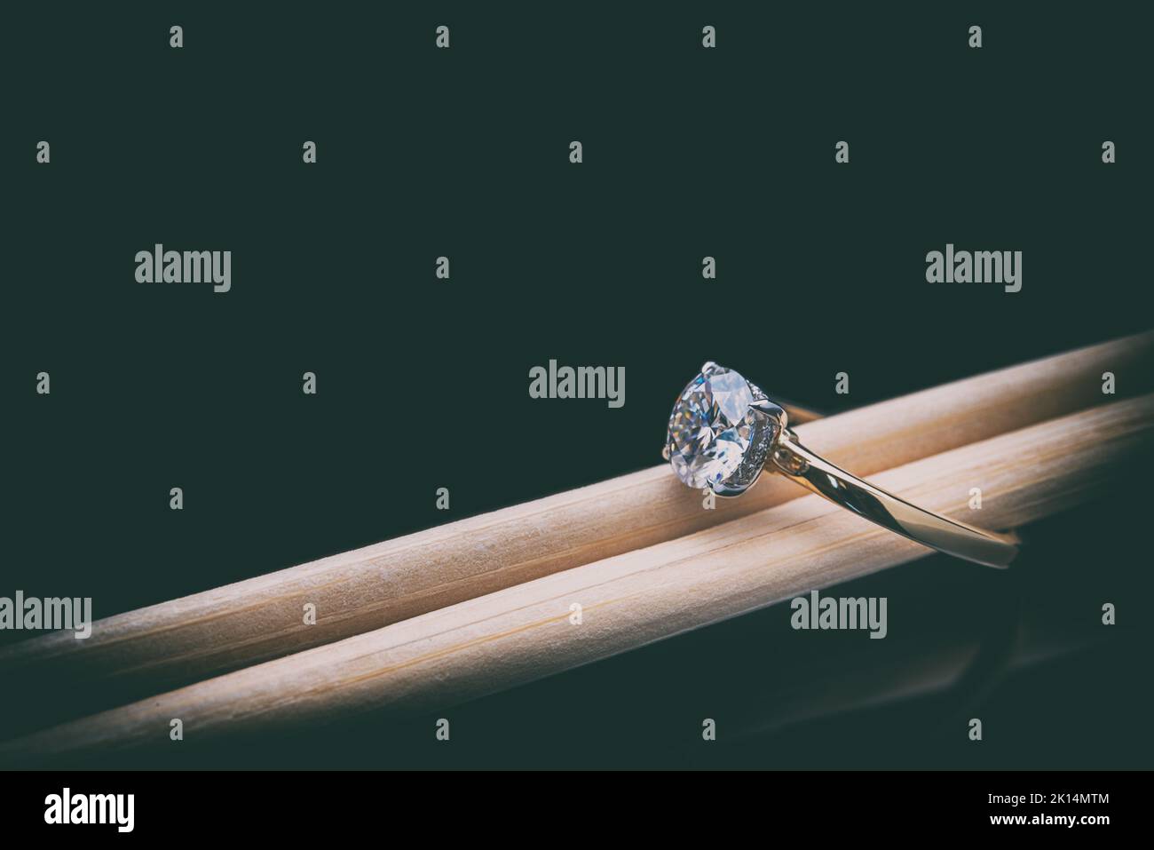 Solitaire Engagement Ring With Diamond on Wooden Chopsticks Stock Photo ...