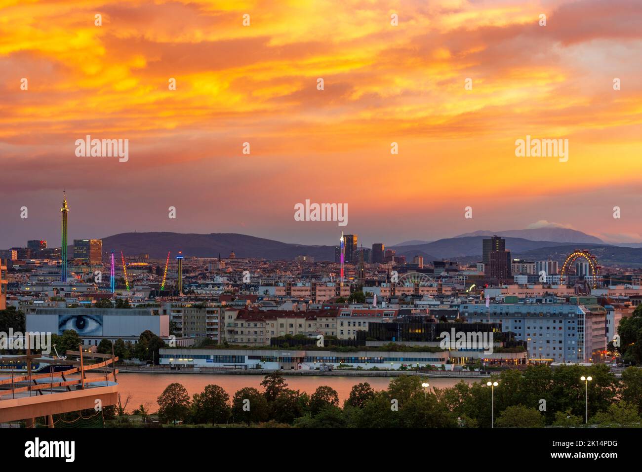 Wien, Vienna: fiery sunset at river Donau (Danube), amusement park ...