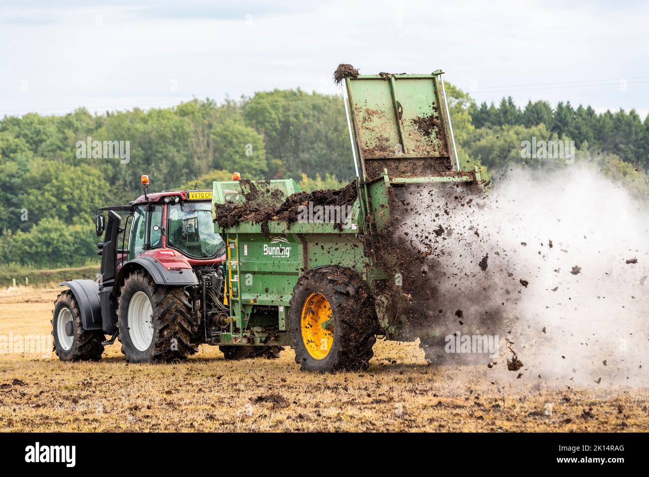 Modern agriculture. Muck spreading prior to ploughing Stock Photo - Alamy