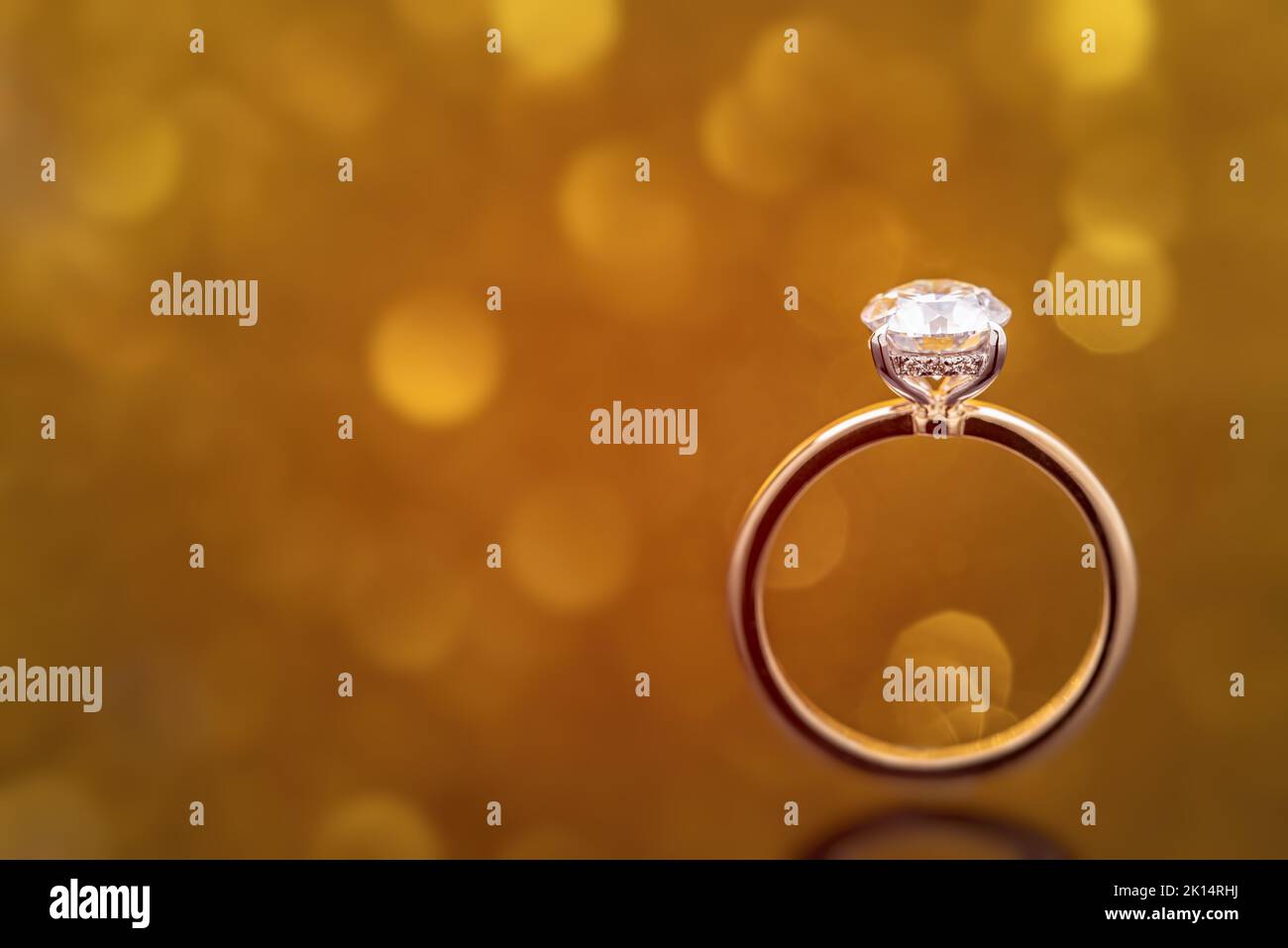 Engagement Diamond Ring on Golden Light Bokeh Background Stock Photo - Alamy
