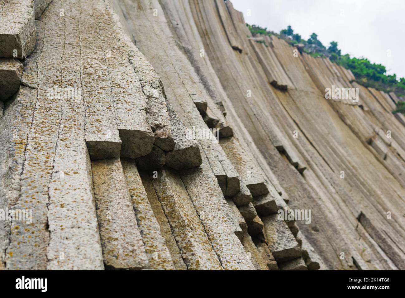 basalt columns forming a coastal rock at Cape Stolbchaty on Kunashir ...