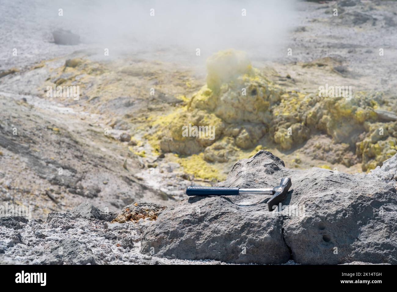 geological hammer on the rock against the backdrop of an steaming ...