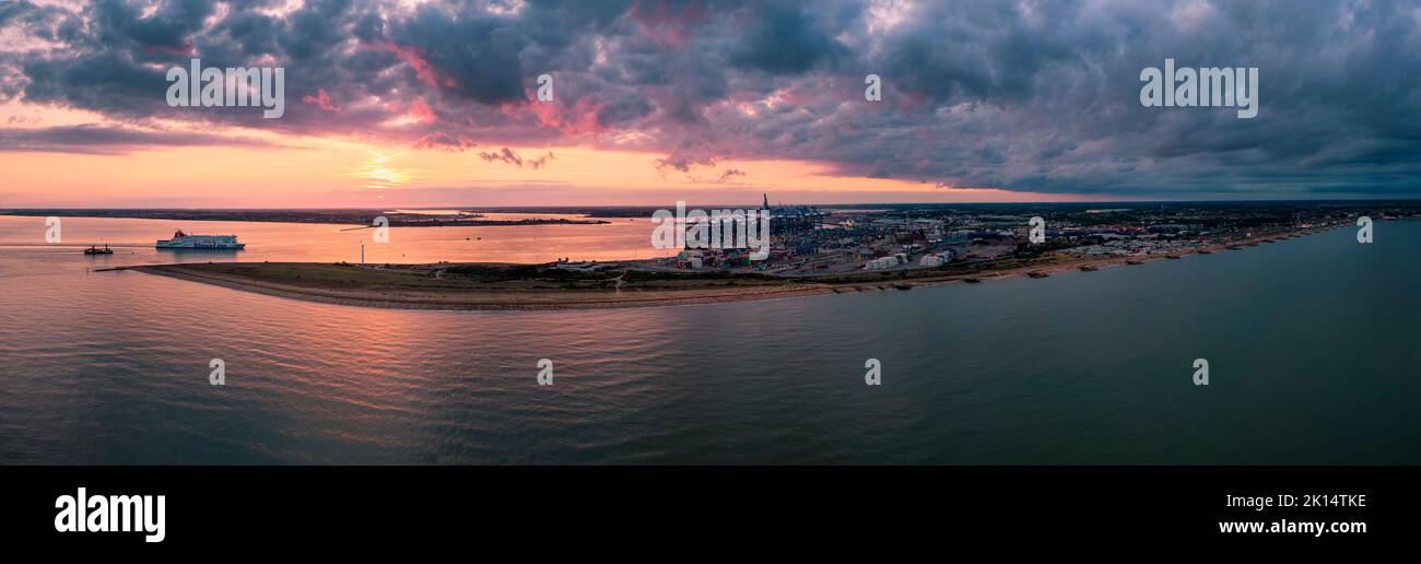 A ferry passing Landguard Point in Felixstowe, Suffolk, UK at sunset ...