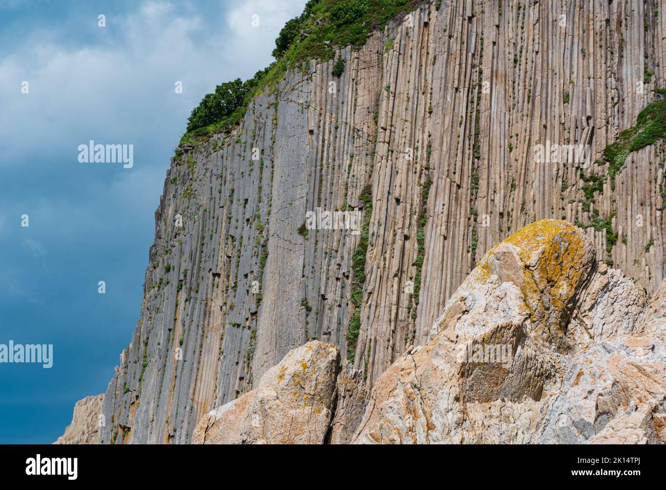 high coastal cliff formed by stone columns, Cape Stolbchaty on the ...