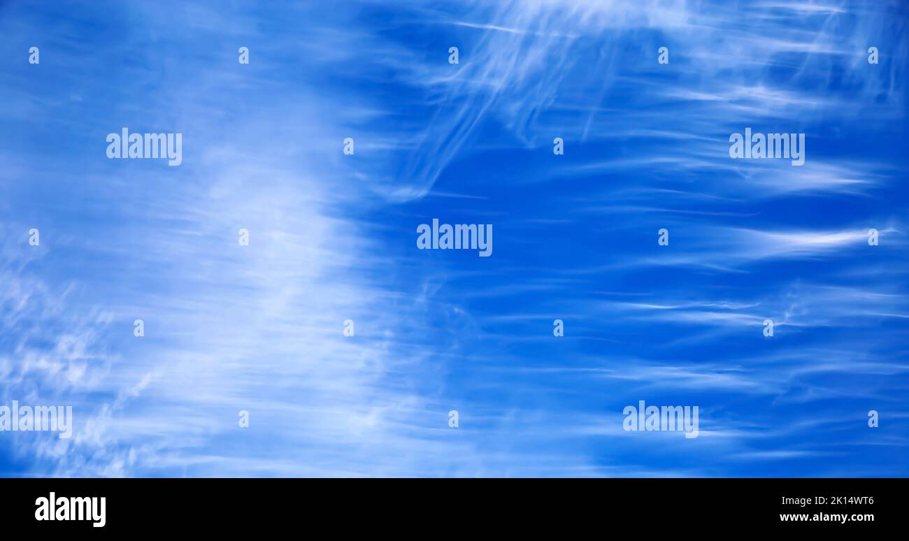 Isolated cloudscape with clear blue summer sky, rippled washed out ...