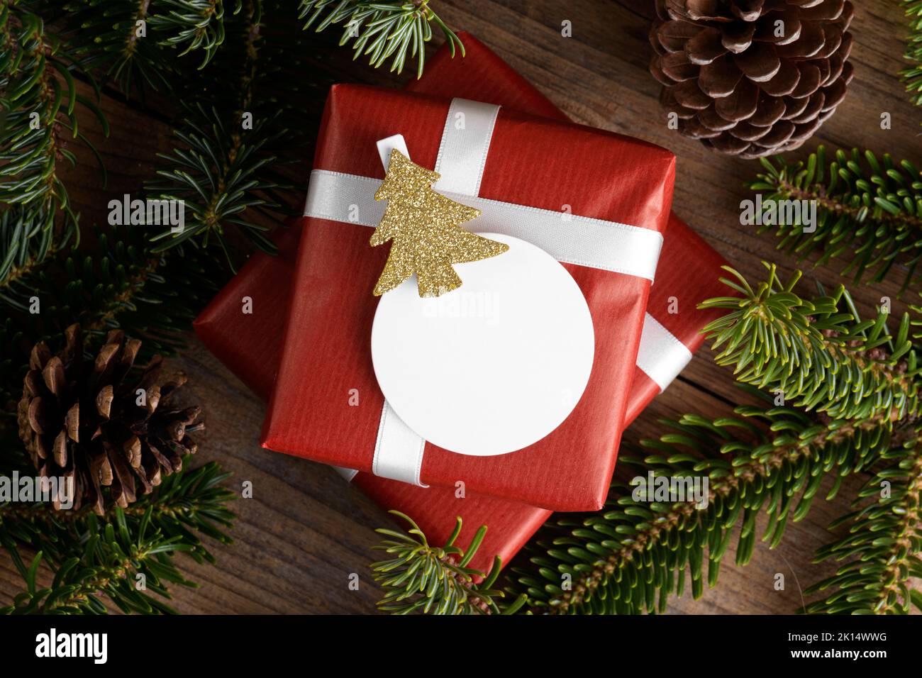 Blank round Christmas gift tag mockup with red present box, product ...