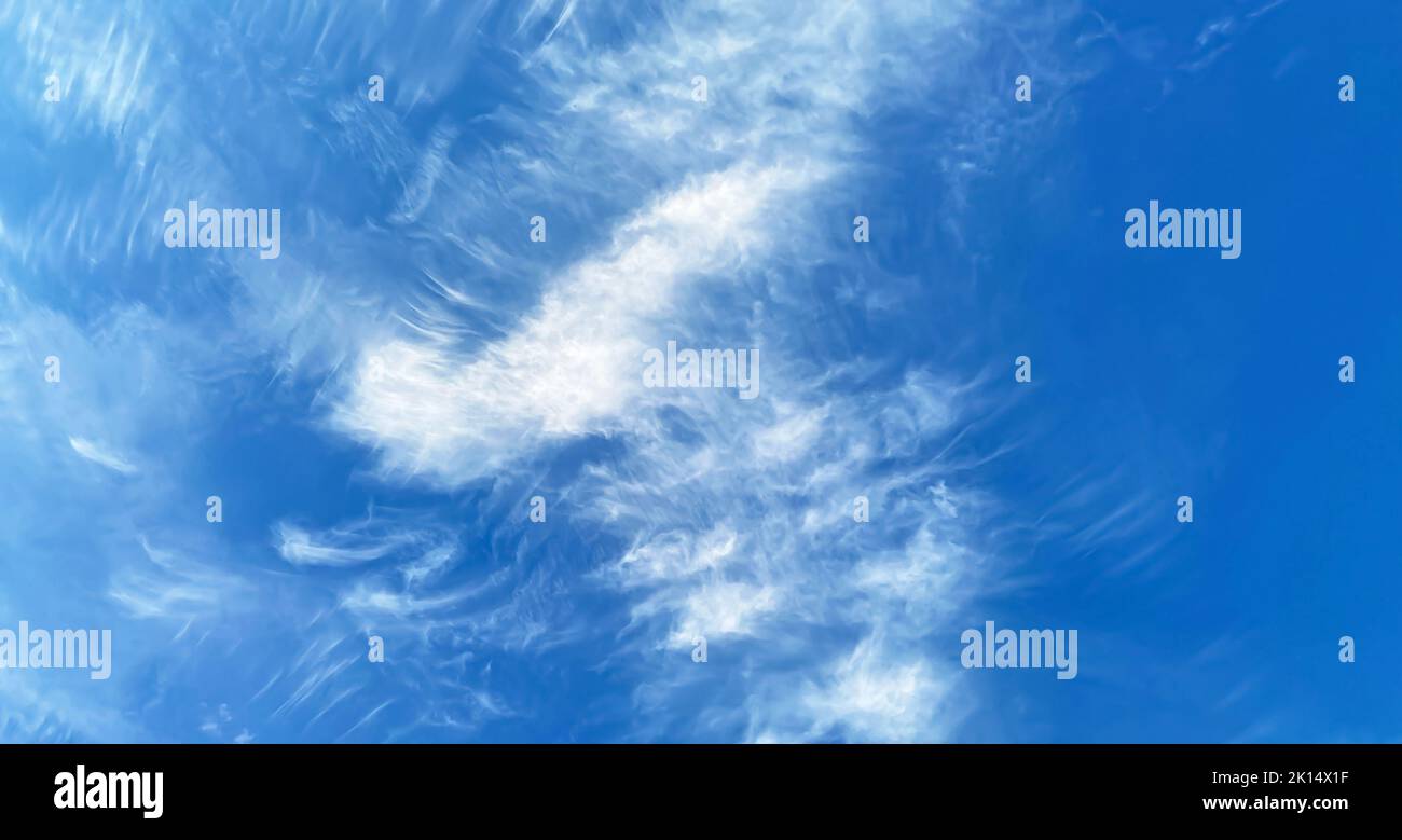 Beautiful blue clear summer sky cloudscape, wind blown white ...