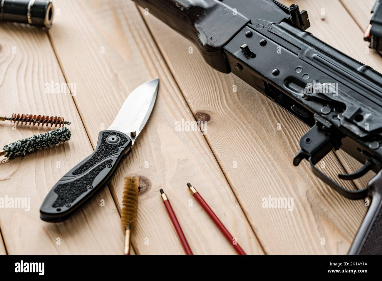 Disassembled rifle with cleaning tools on table of weapons workshop ...