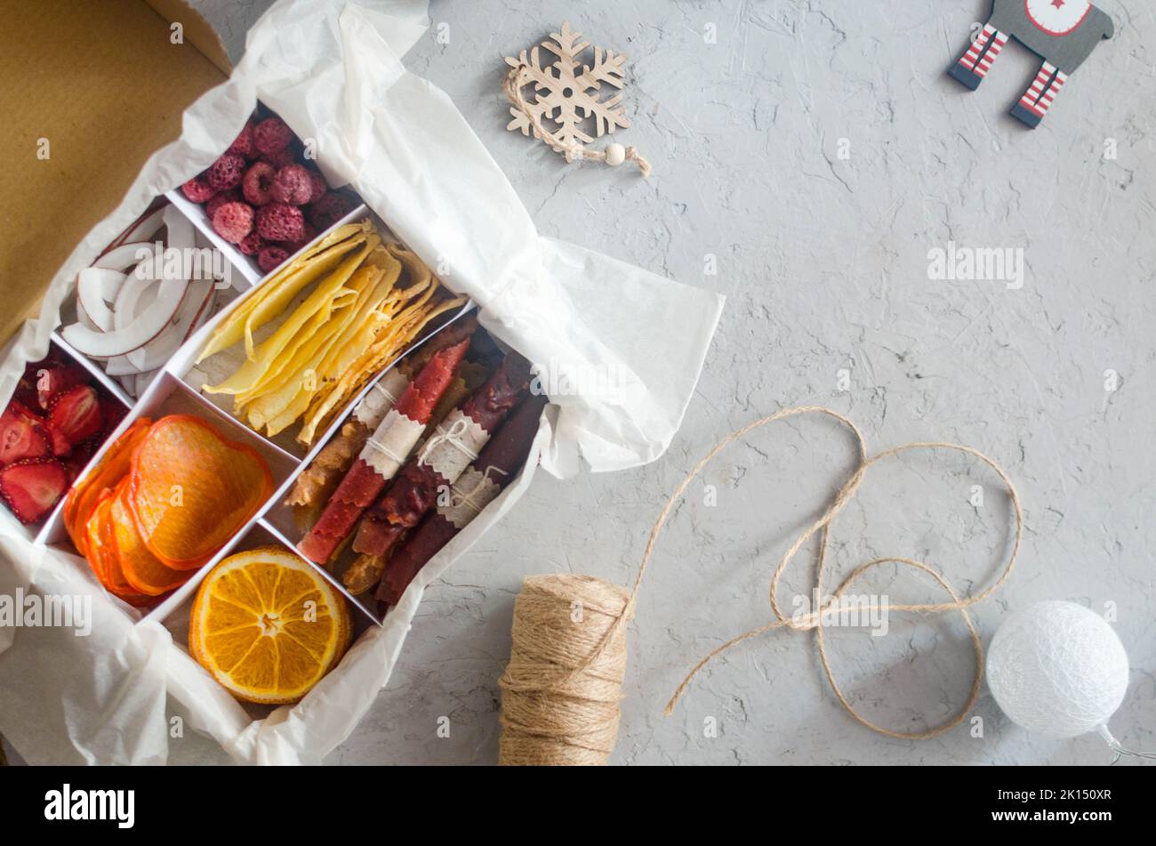 assorted handmade natural organic dried chips in box on grey background ...