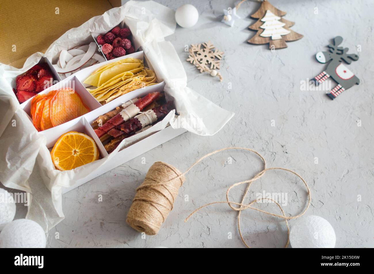 assorted handmade natural organic dried chips in box on grey background ...