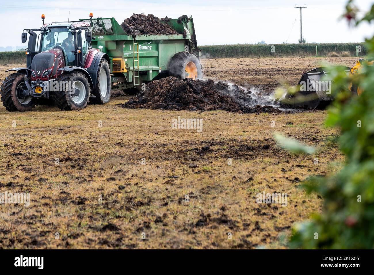 Modern agriculture. Muck spreading prior to ploughing Stock Photo - Alamy