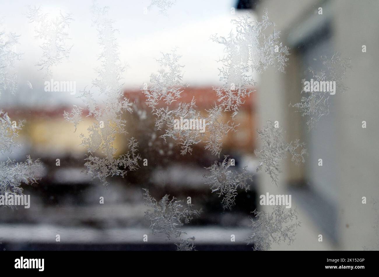 Frosted frozen ice crystals on a city window in icy London winter ...