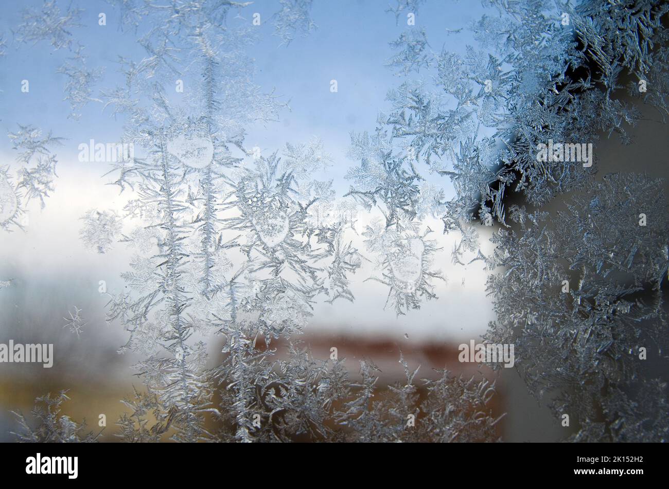 Frosted frozen ice crystals on a city window in icy London winter ...