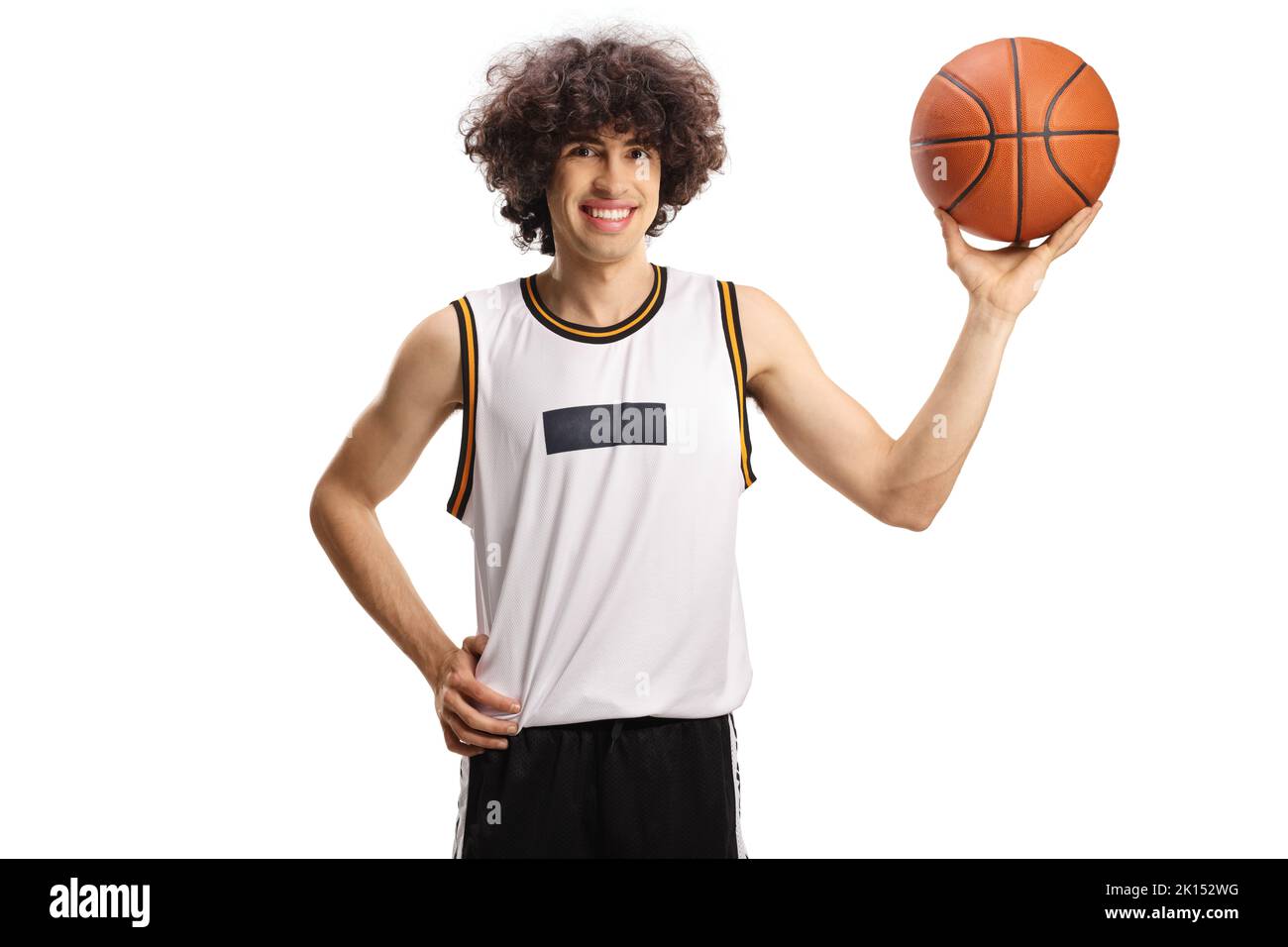 Basketball player holding a ball and smiling isolated on white ...