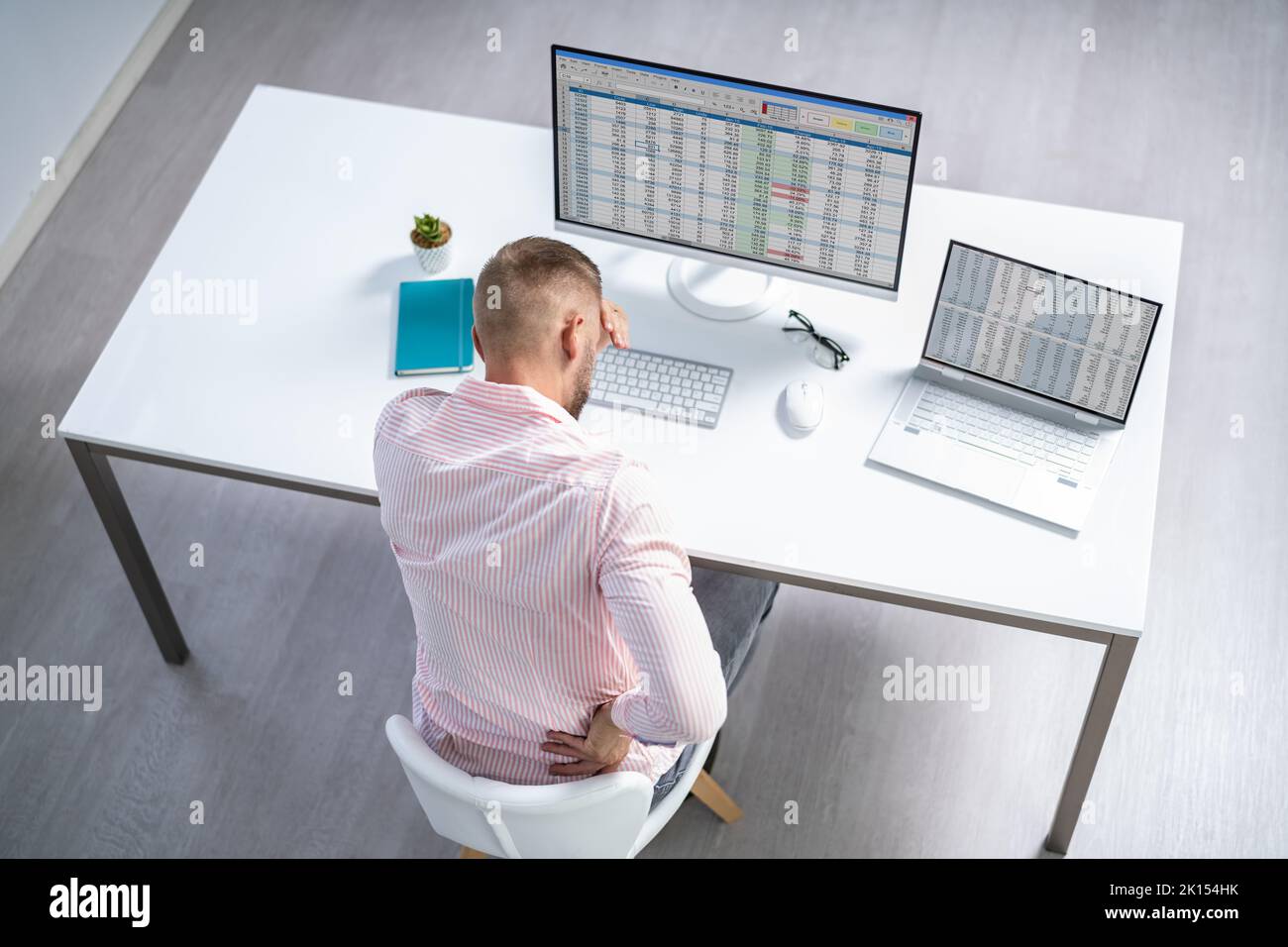 Back Pain Bad Posture Man Sitting In Office Stock Photo - Alamy