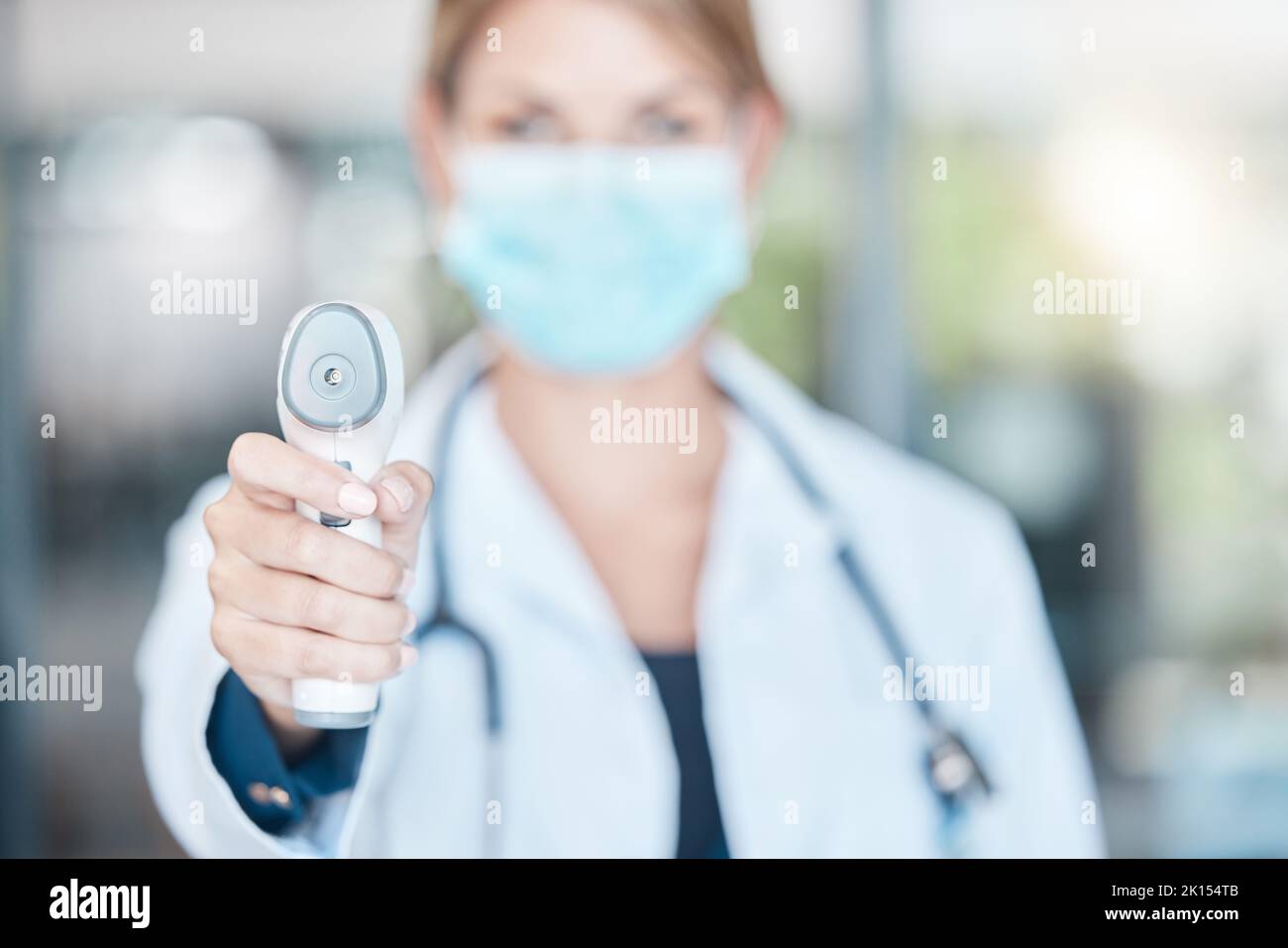 Thermometer, covid face mask and doctor check temperature for hospital ...