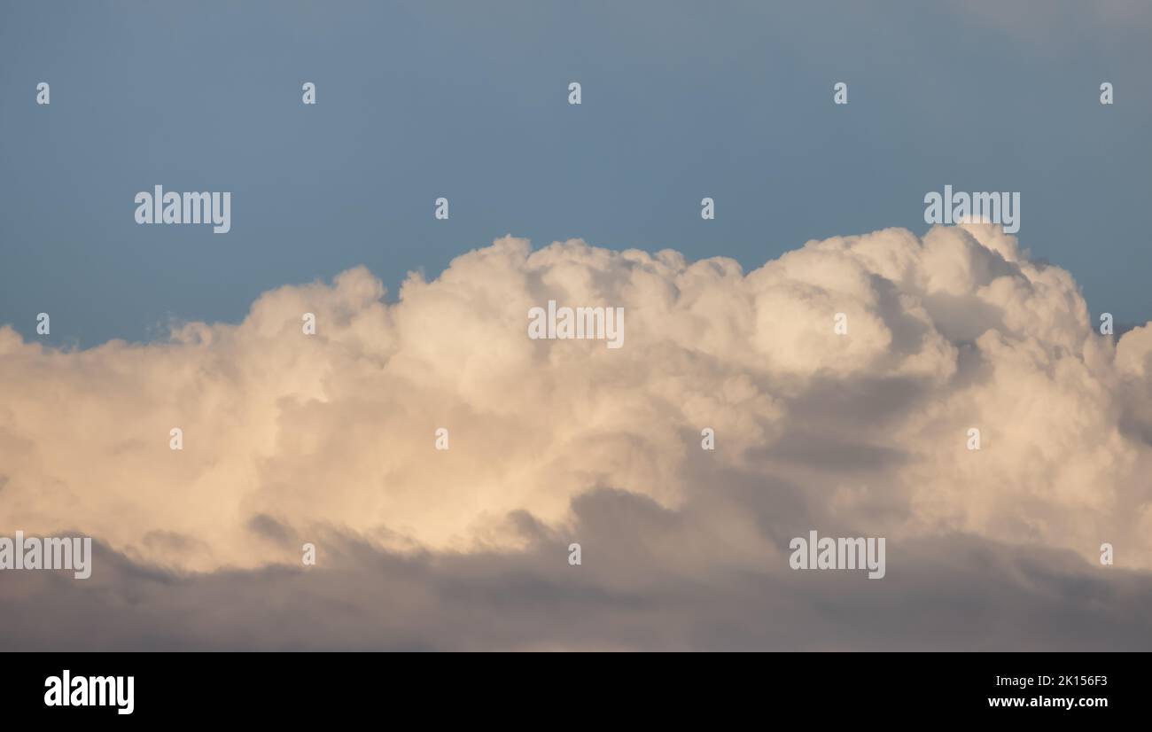 Puff Clouds in the Sky during sunset. Zoom in Stock Photo - Alamy